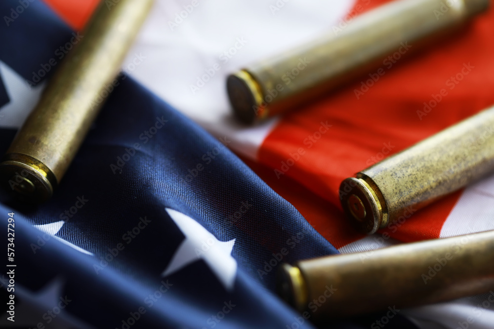Many bullets cartridges and medals on United States flag. Concept of ...
