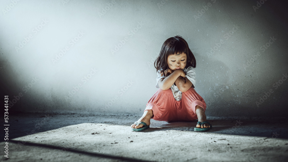 Homeless sad little child girl sitting alone on floor concrete wall ...