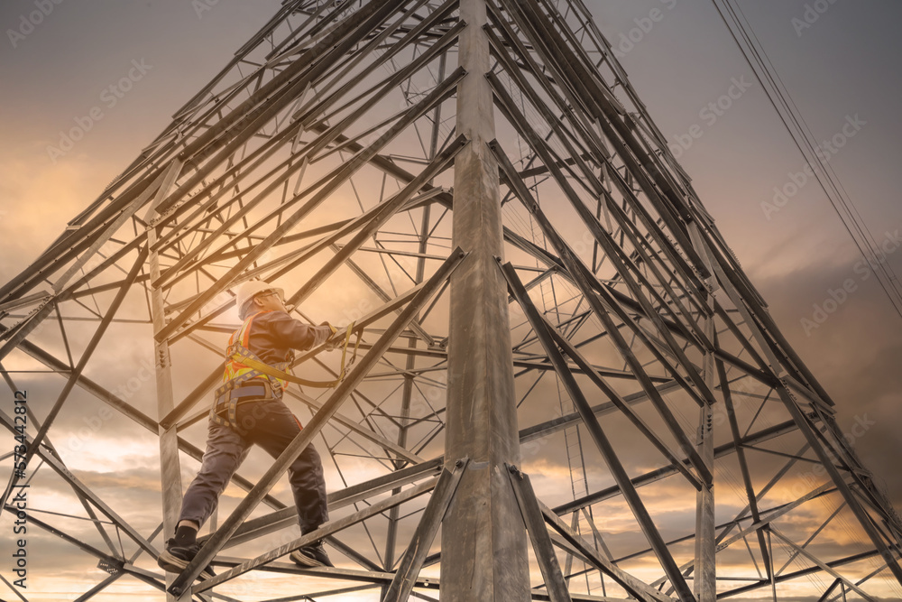 Asian electrical engineer wearing safety gear working high voltage ...