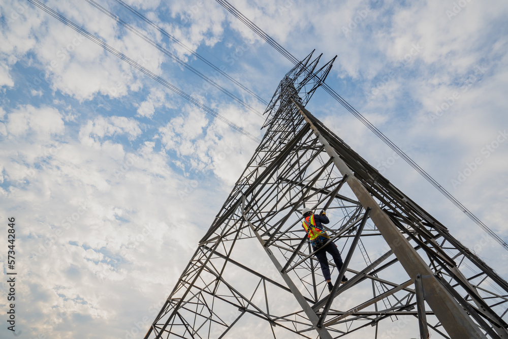 Asian electrical engineer wearing safety gear working high voltage ...