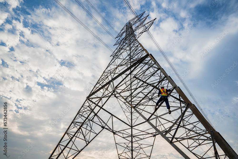 Asian electrical engineer wearing safety gear working high voltage ...