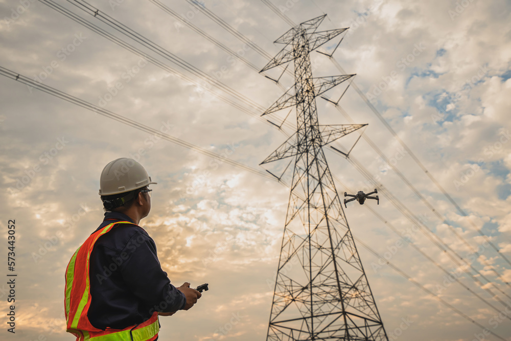 Asian electrical engineer wearing safety gear working high voltage ...