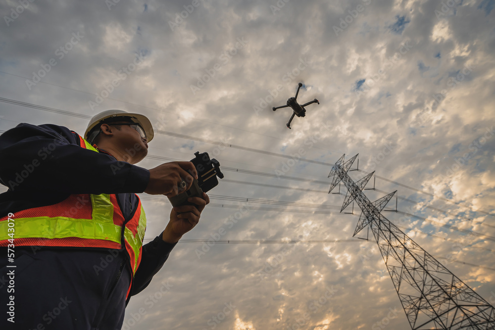 Asian electrical engineer wearing safety gear working high voltage ...