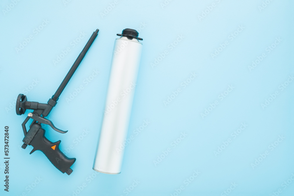Black dark professional foam spray gun with gray container on light ...