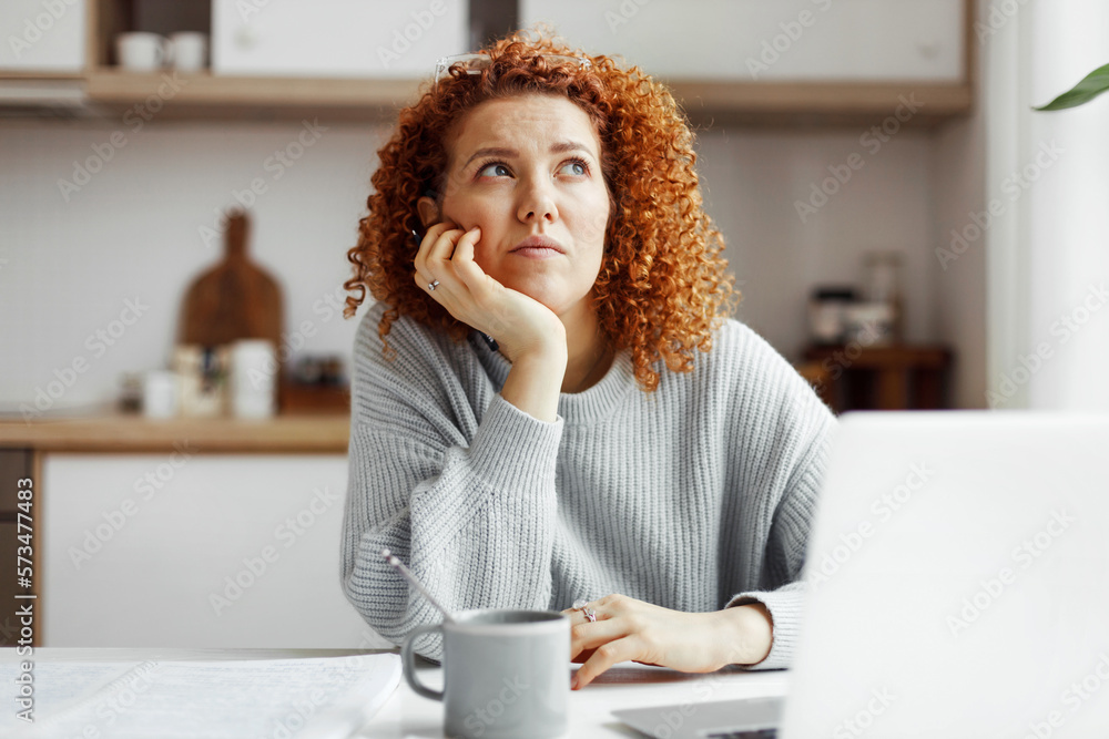 Charming ginger-headed female with glasses on head looking up with ...