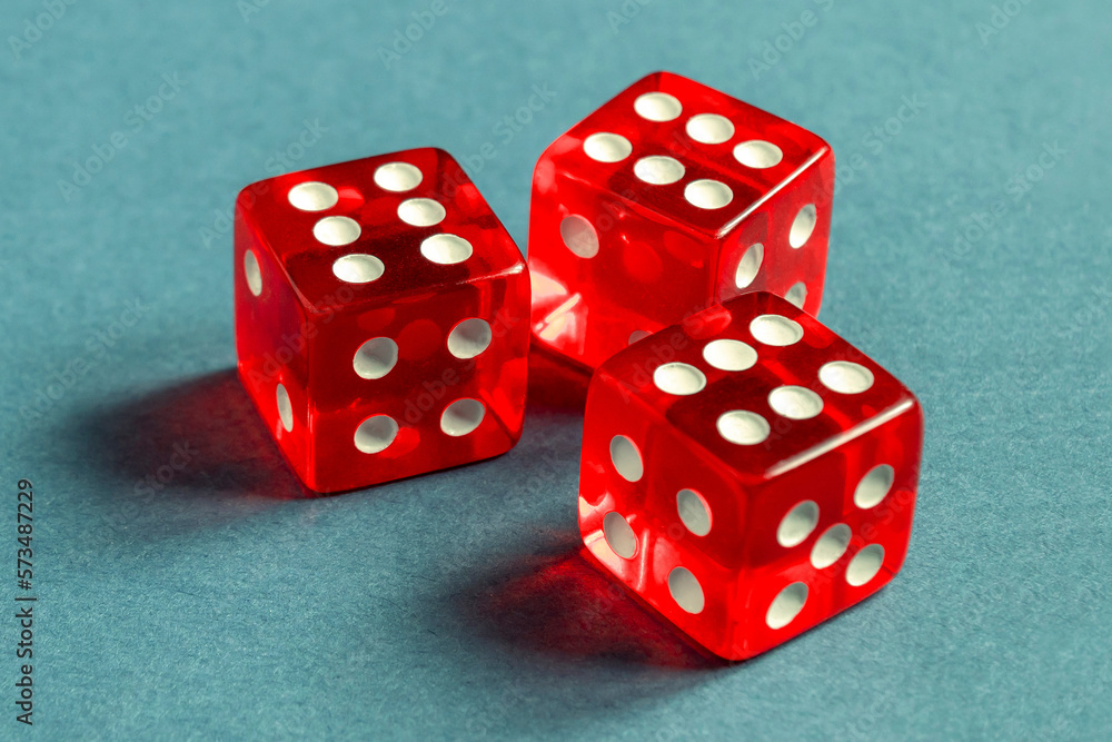 Random number generator. Three red dice with numerical values lie in a ...