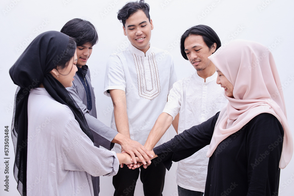 Muslim people group giving each other high-five in a symbol of unity ...