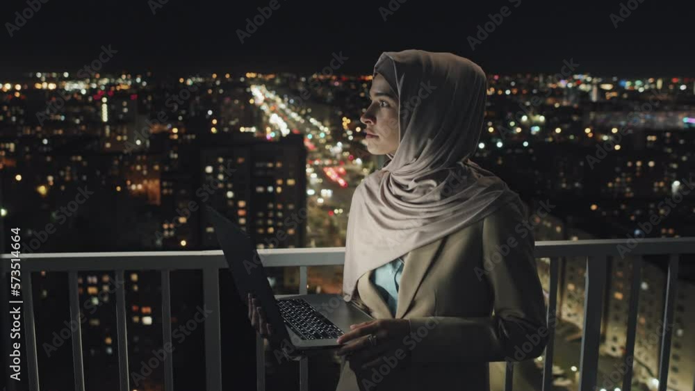 Medium side shot of young Muslim office worker wearing jacket and hijab ...