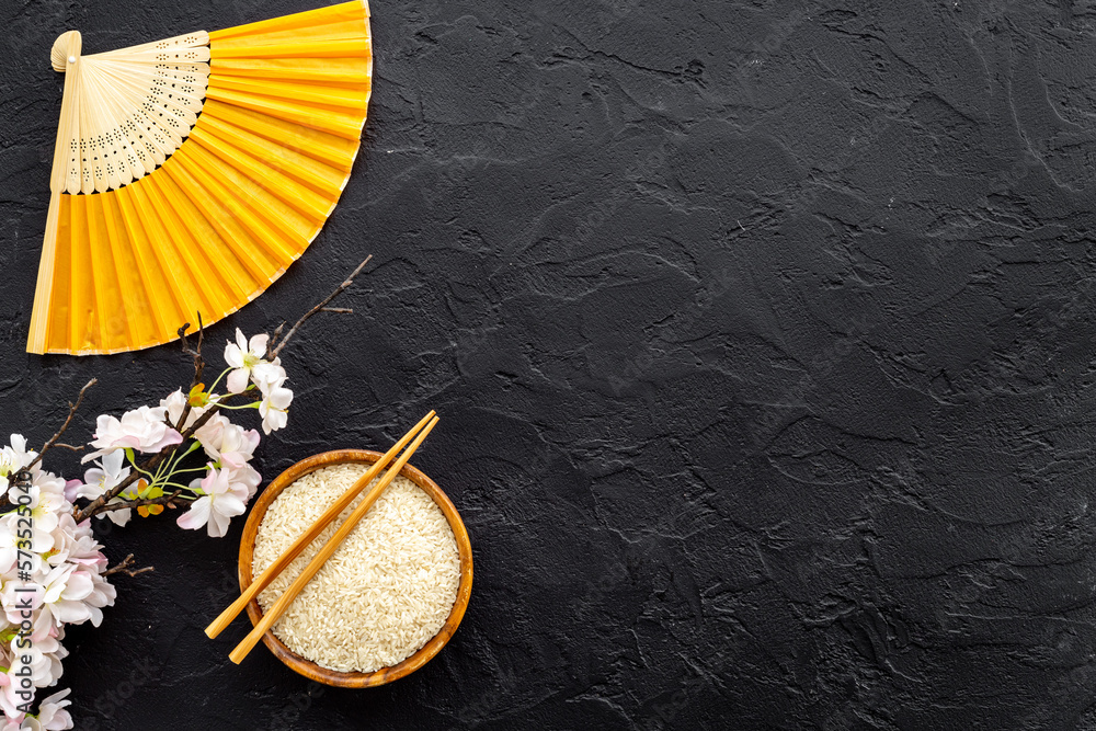 Chinese or Japanese background with bowl of rice and fan, top view ...