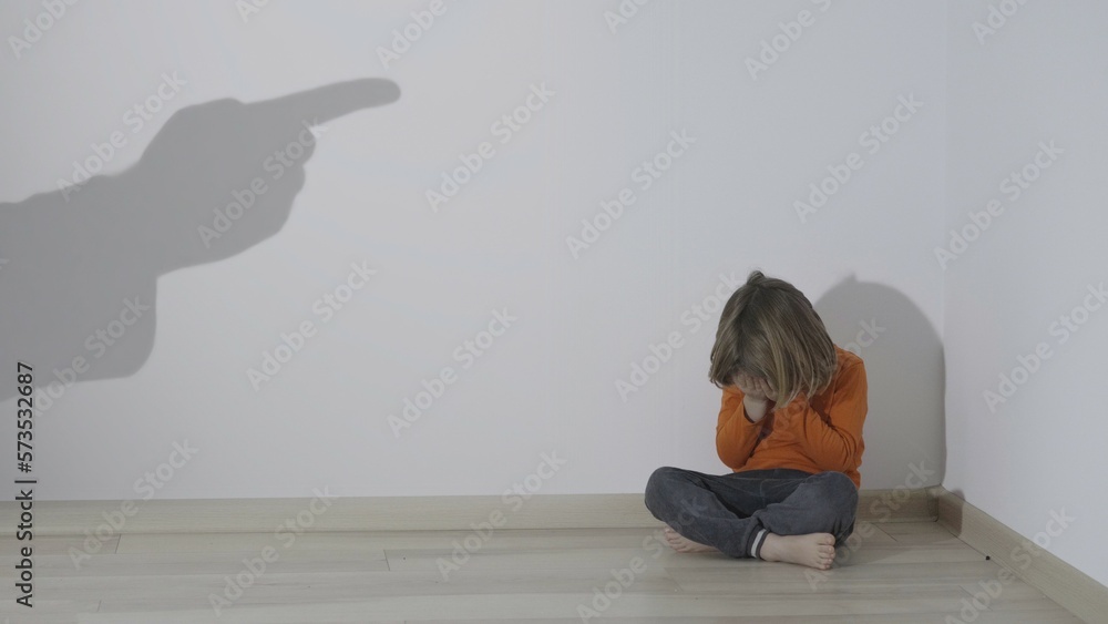 Hand shadow pointing with finger reflected on wall threatening scared ...