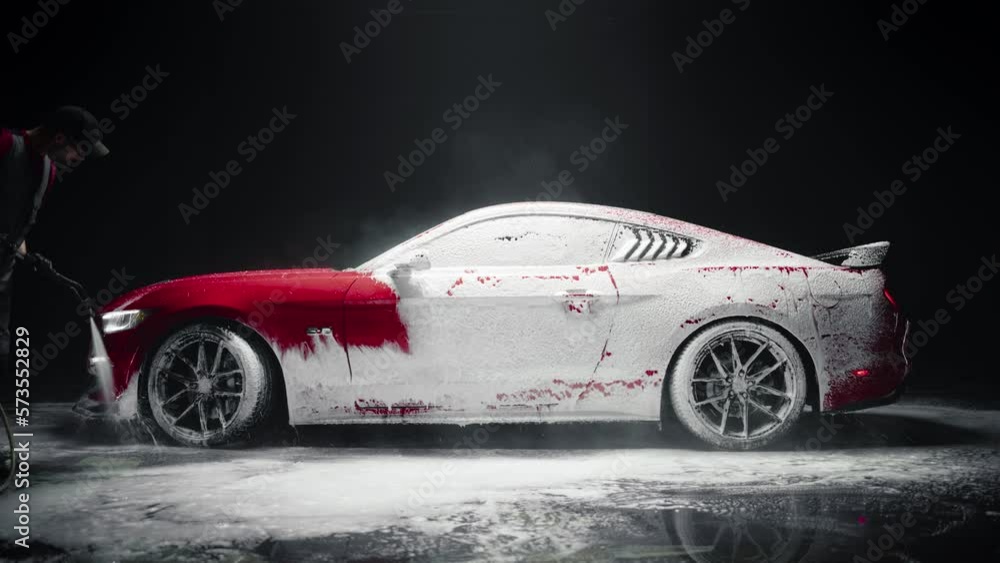 Automotive Detailer Washing Away Smart Soap and Foam with a Water High ...