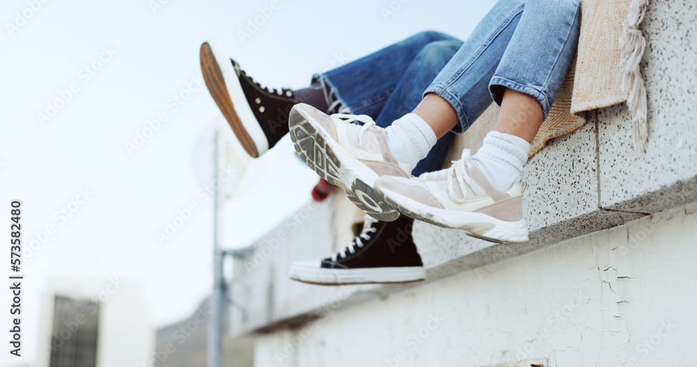 Shoes, legs and couple on rooftop in the city sitting together, have ...