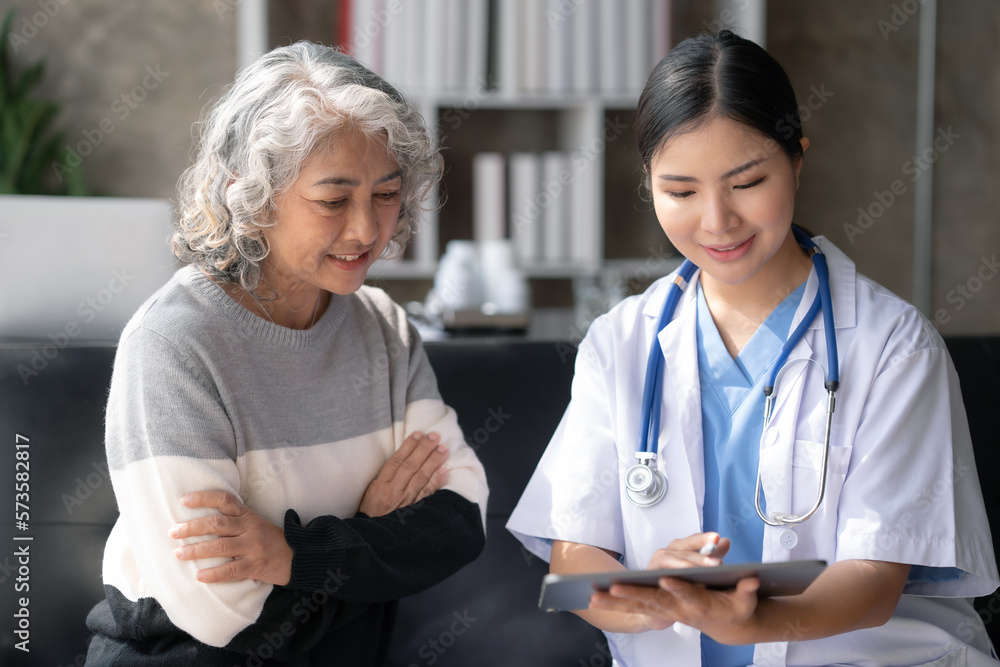 Asian female doctor examining a patient to assess the illness for ...