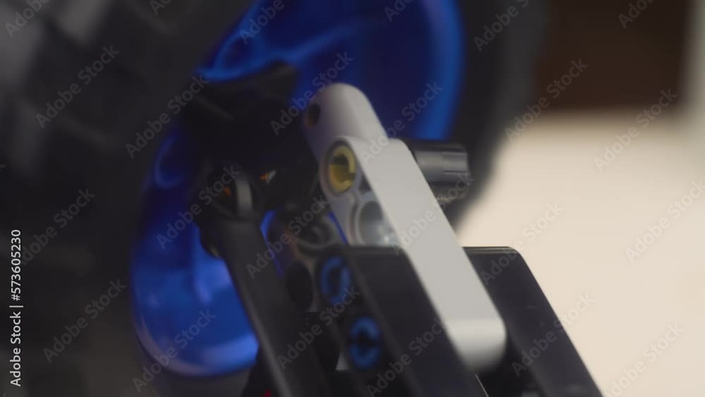 Demonstration of spinning wheels on chassis of toy car constructor for ...