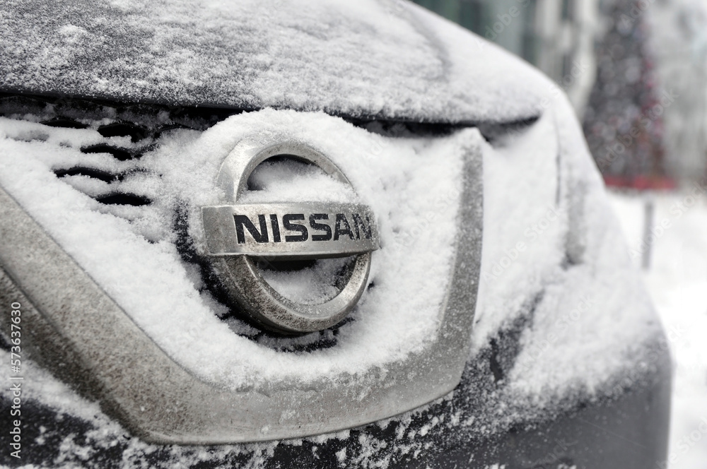 Nissan car logo on the grille under a layer of snow. Stock Photo ...