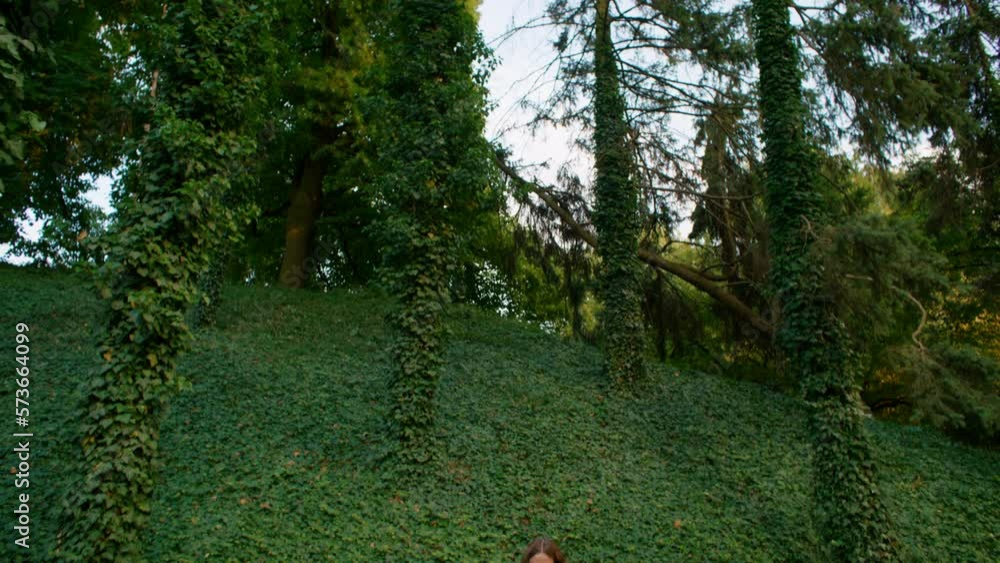 Flexible Woman exercises Advanced Yoga Pose among Trees. Sporty Lady ...