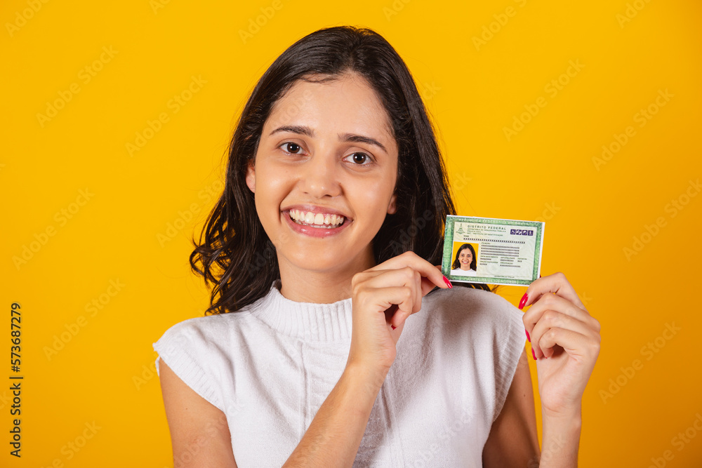 beautiful brazilian woman holding rg, brazilian identification document ...