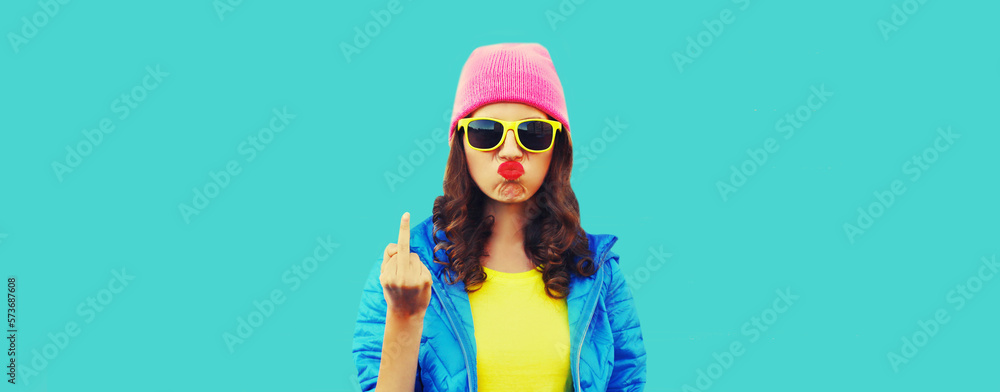 Portrait of bad girl expression showing hand with middle finger sign ...