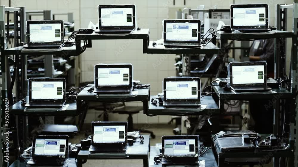 Many Laptops on Charging Station In the Production Line of a Computer ...