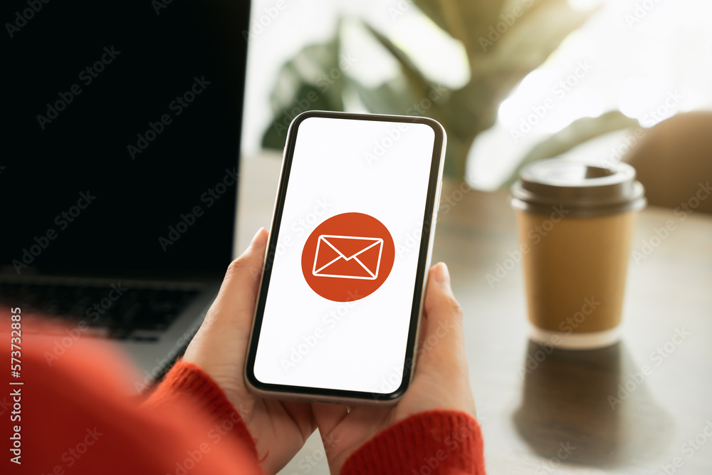Hand holding smartphone and show a digital screen of new email ...