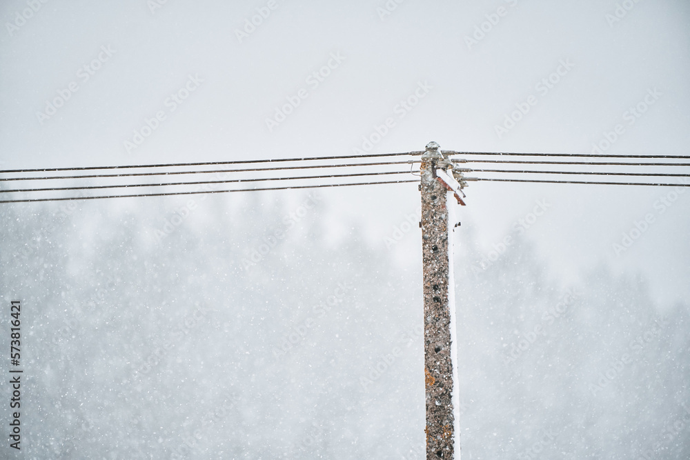 Heavy snow on electrical wires. Frozen electric wires in the city ...