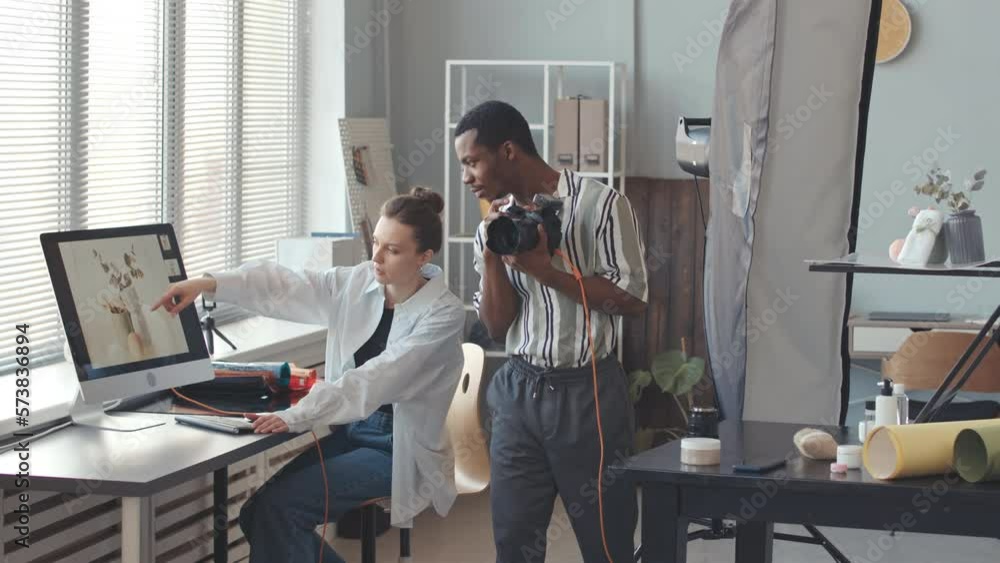 Multiethnic photographer team editing aesthetic still life photos on ...
