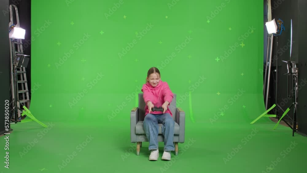 Young caucasian girl sitting on a chair, Playing and winning in Video ...