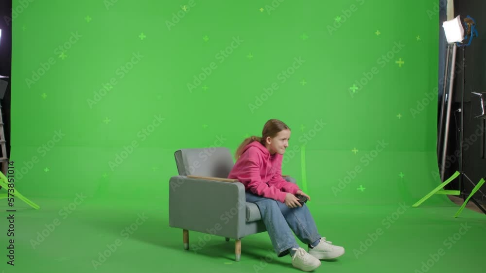 Young caucasian girl sitting on a chair, Playing and winning in Video ...