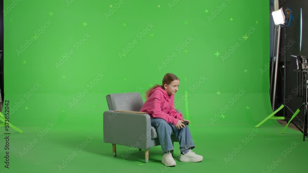 Young caucasian girl sitting on a chair, Playing and winning in Video ...