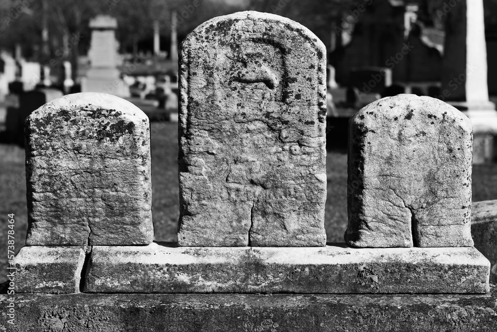 blank vintage old tombstone in a graveyard in a black and white ...
