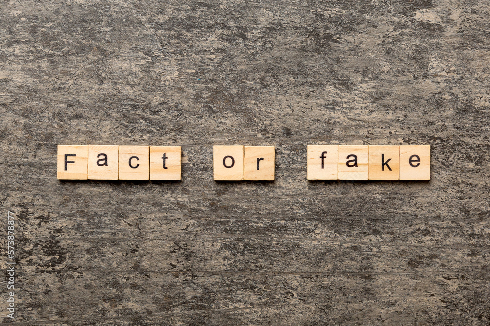 fact or fake word written on wood block. fact or fake text on table ...