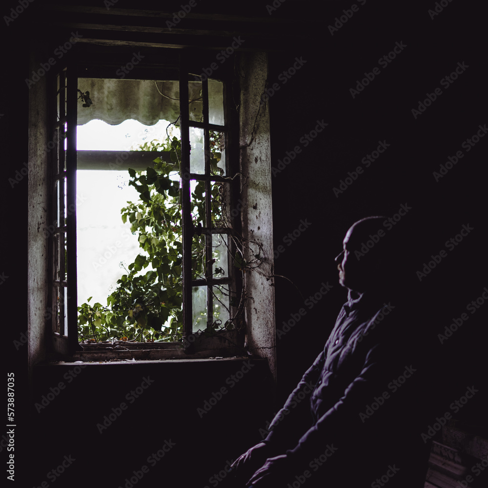 Window view from inside an old uninhabitable house and a blurred ...
