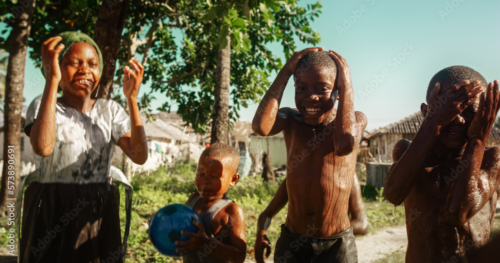 Group of African Kids Jumping and Laughing when Water Gets Poured on ...