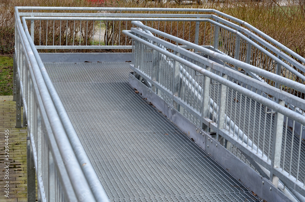 metal railings and metal grid on the floor. instead of stairs, there is ...