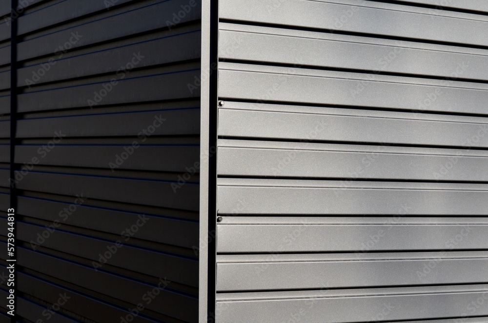 gray building is lined with square panels. metal sheet wall cladding ...