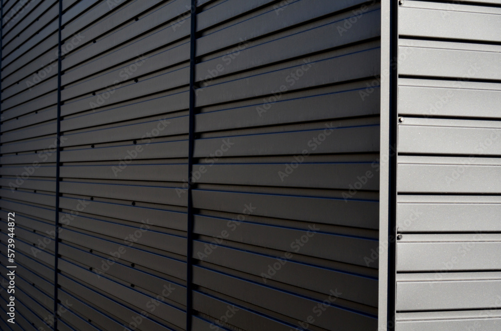 gray building is lined with square panels. metal sheet wall cladding ...