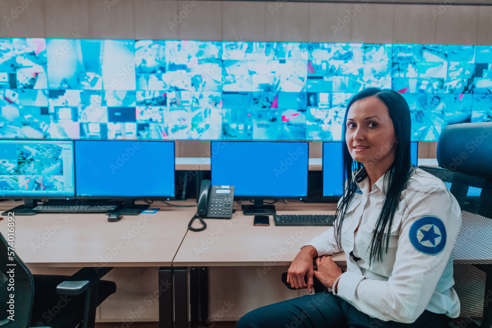 Female security operator working in a data system control room offices ...