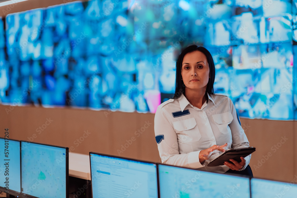 Female security operator working in a data system control room offices ...