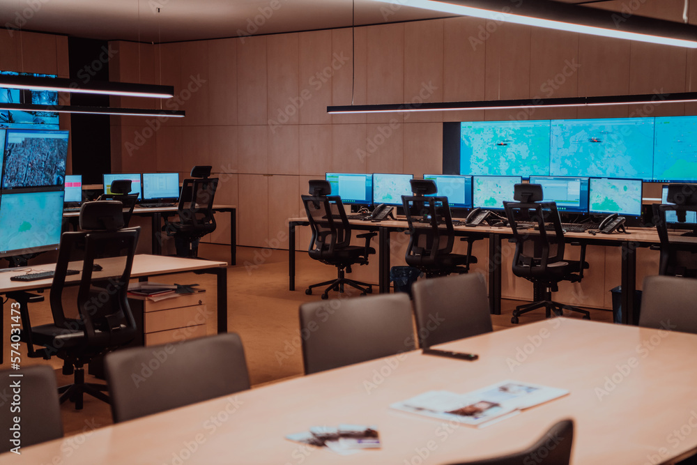 Empty interior of big modern security system control room, workstation ...