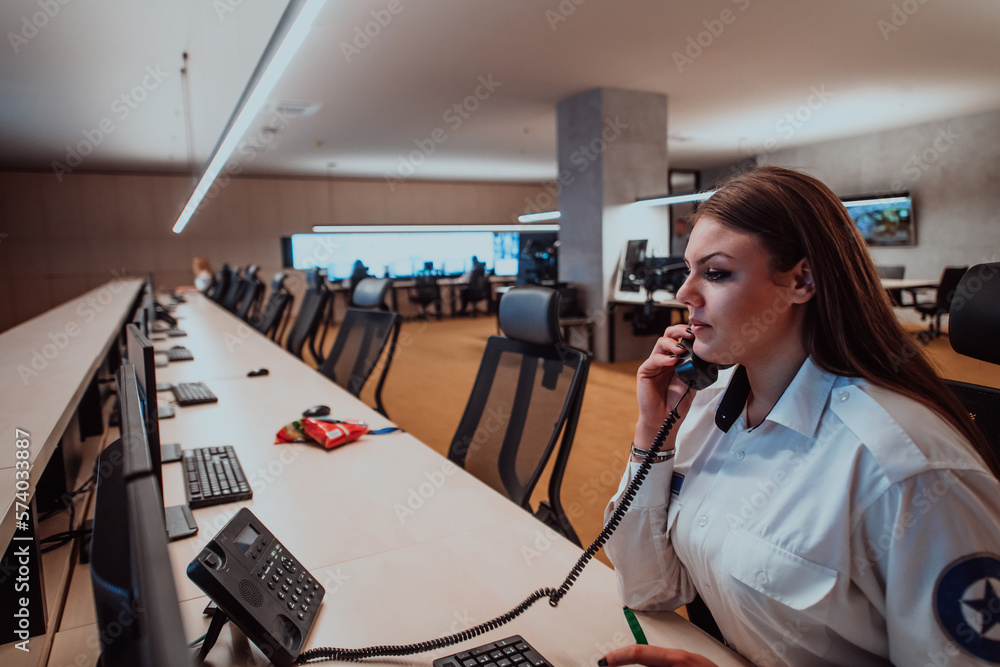 Female security operator working in a data system control room offices ...