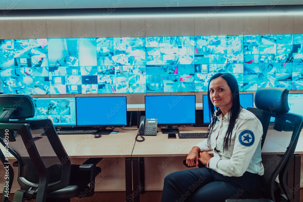 Female security operator working in a data system control room offices ...