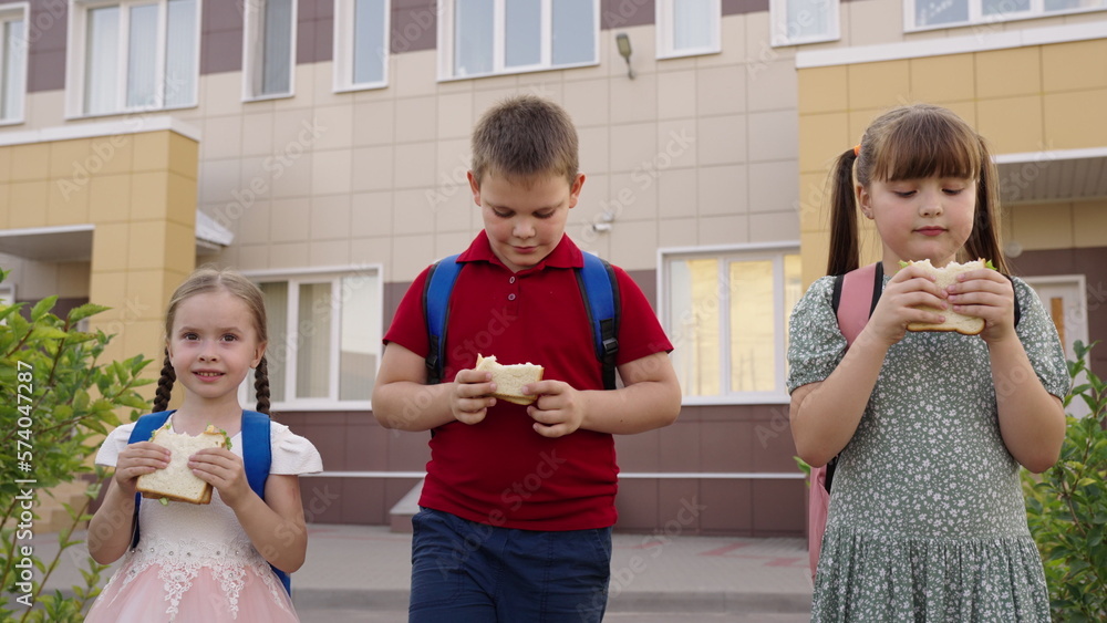 small children eat sandwiches. full child concept. boy girl have ...