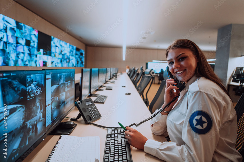 Female security operator working in a data system control room offices ...