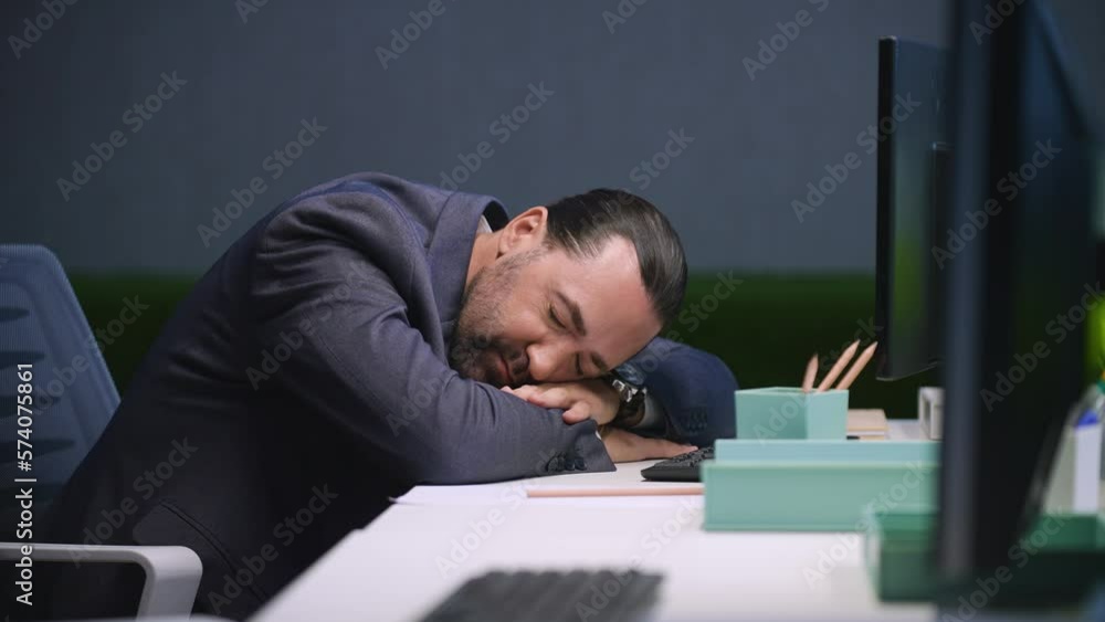 Close up man employee in a suit fell asleep at the office desk, resting ...