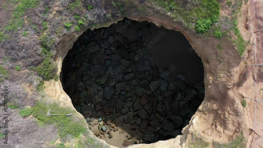 Mesmerizing drone shot captures the unique view of a circular hole ...