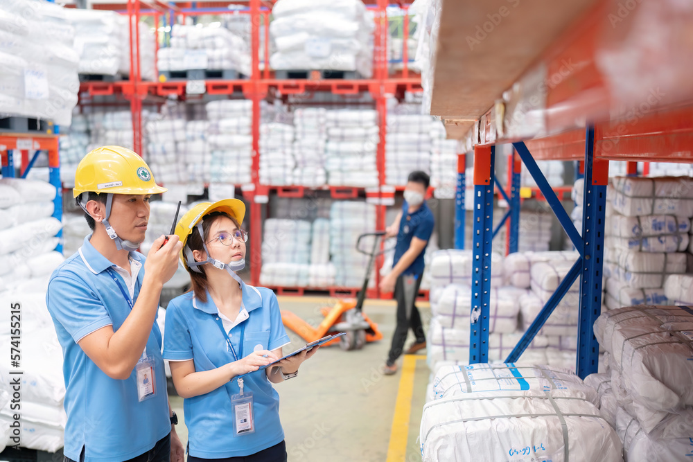 A team of Asian leaders and engineers stand by to check product systems ...