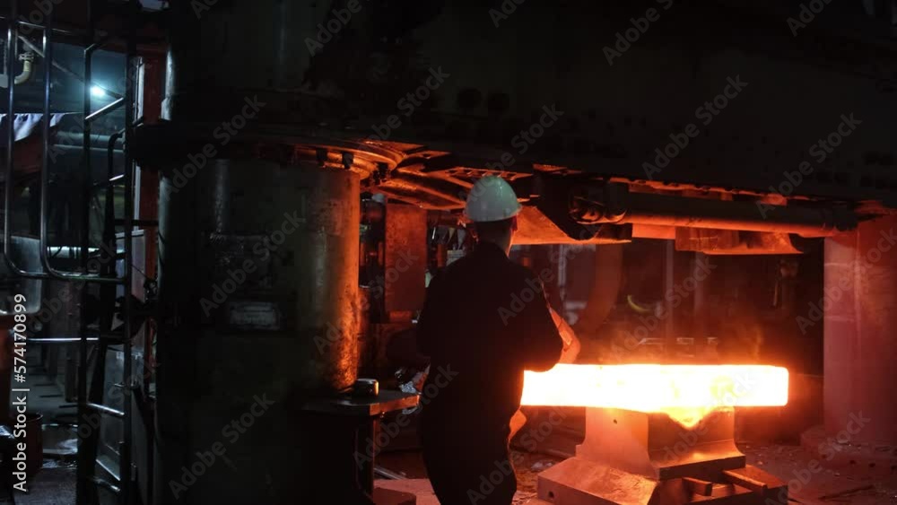 Blacksmith factory. Close-up of robots work. Forging a large hot metal ...
