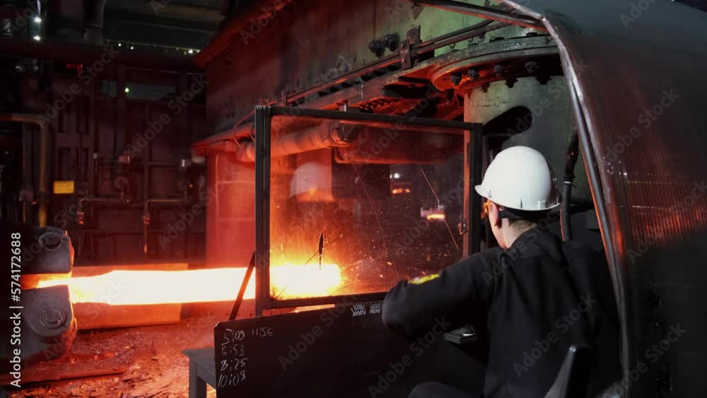 Blacksmith factory. Close-up of robots work. Forging a large hot metal ...