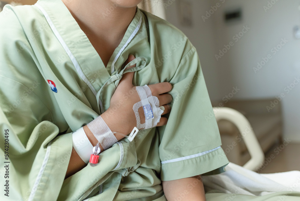teenager sick and in pain and uses his hands to squeeze his chest chest ...