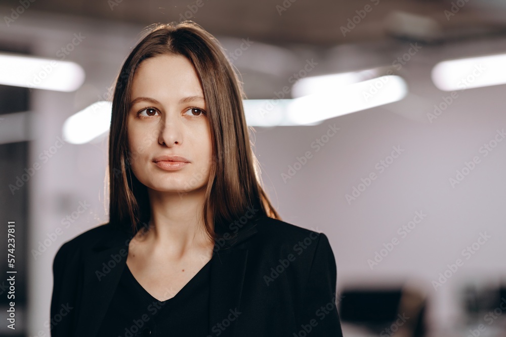 Serious young businesswoman looking away. Portrait of beautiful female ...
